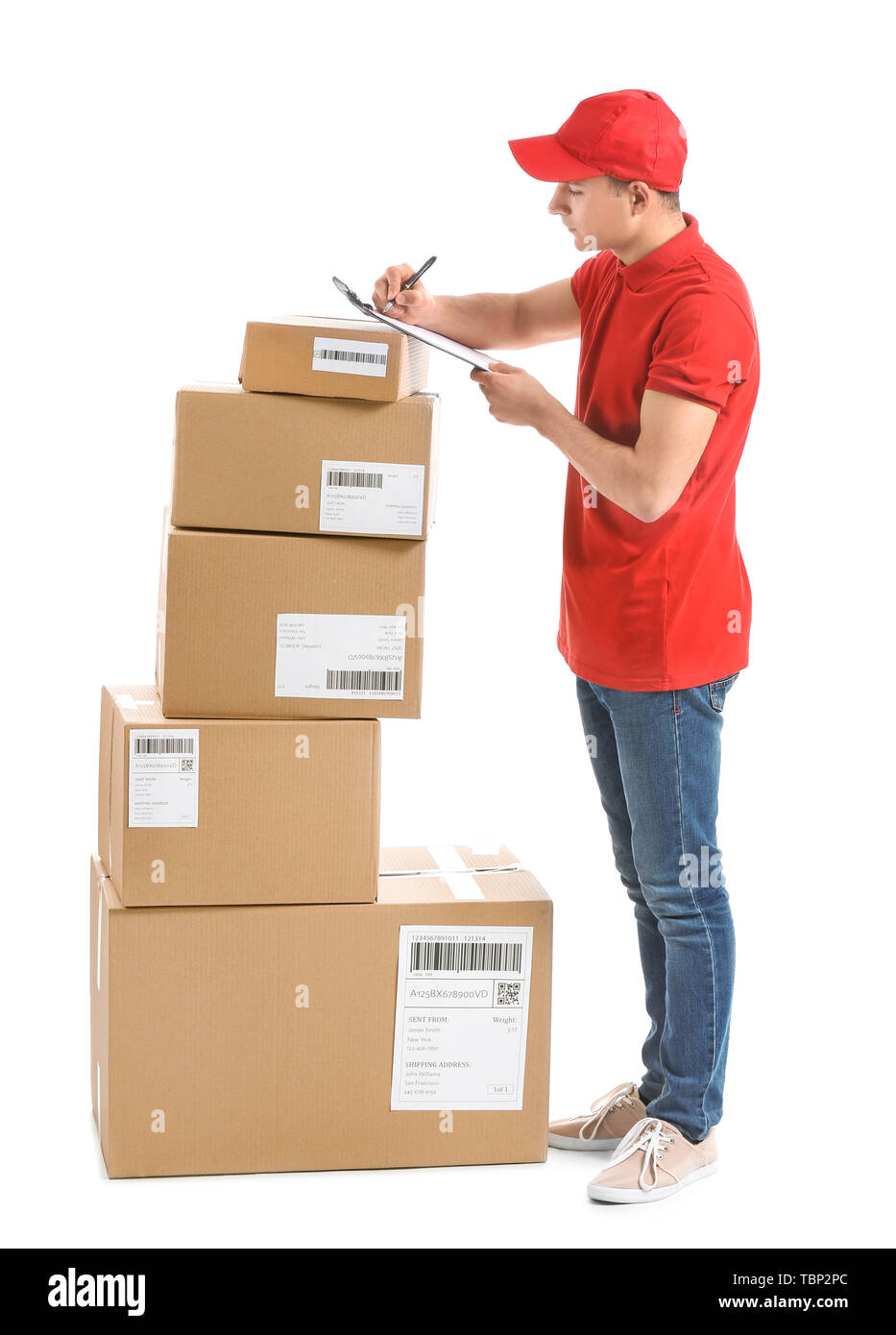 Delivery man with boxes and clipboard on white background Stock Photo ...