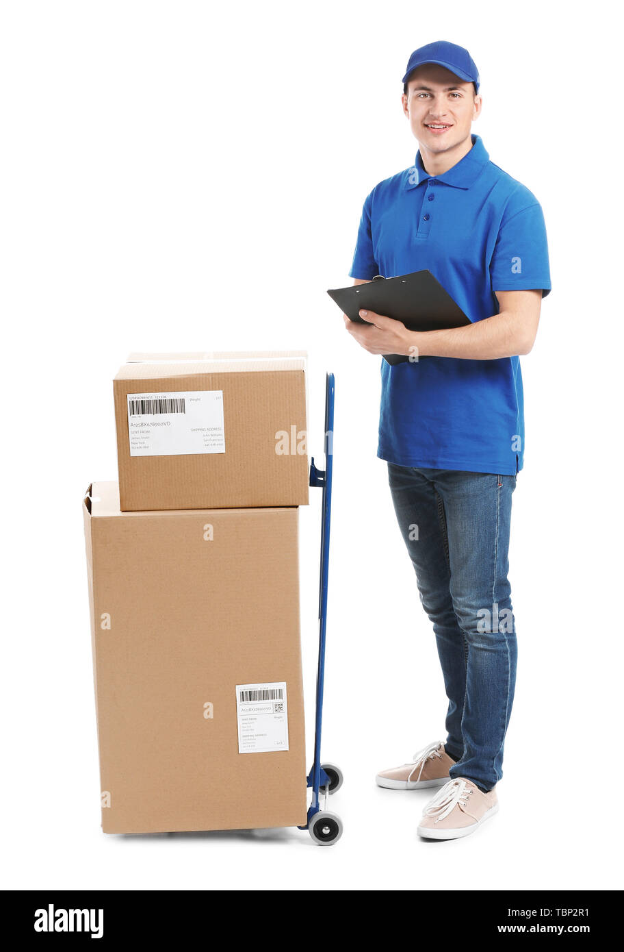 Delivery man with boxes and clipboard on white background Stock Photo ...