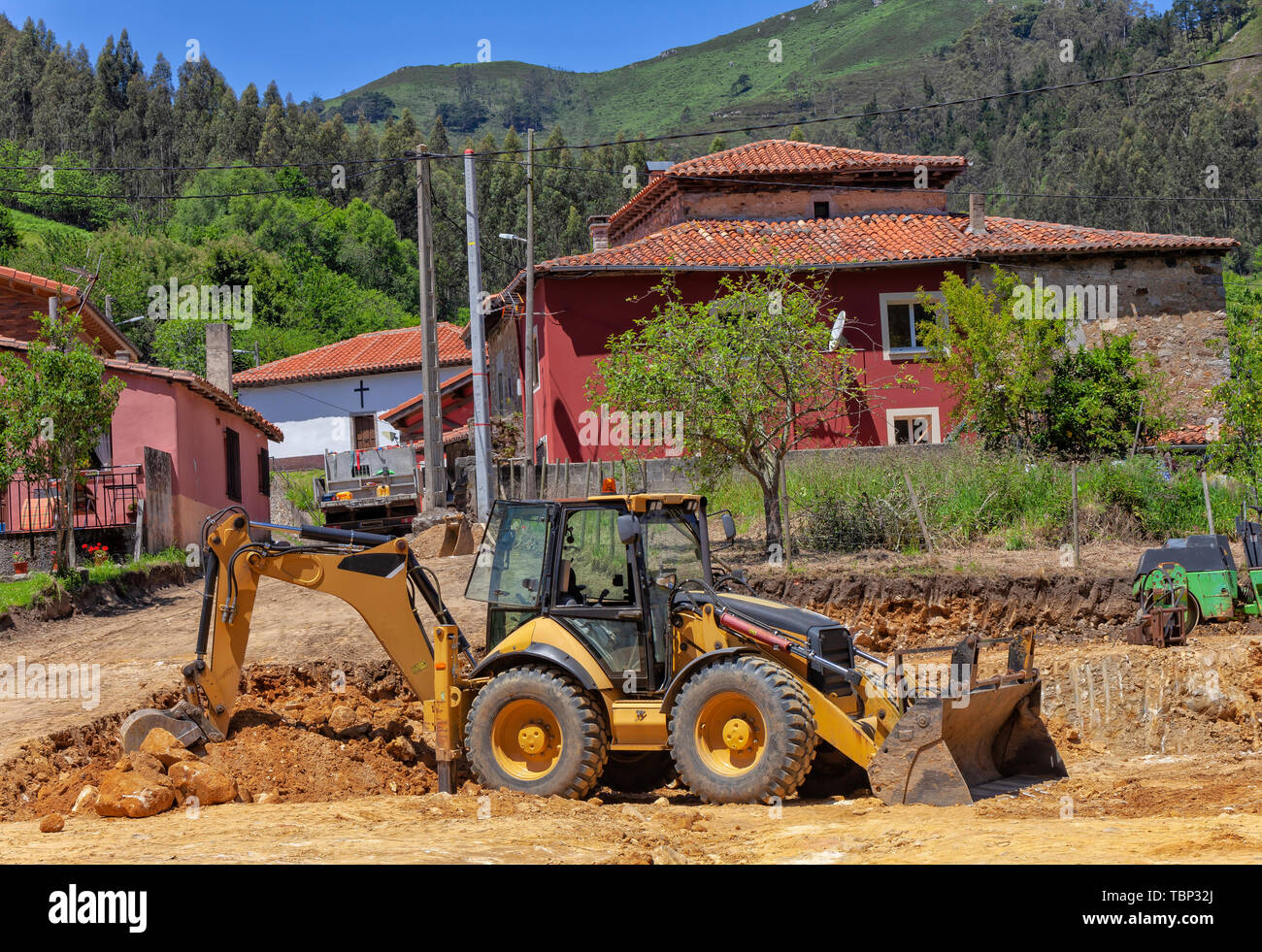 A backhoe excavating earth in a construction site Stock Photo - Alamy