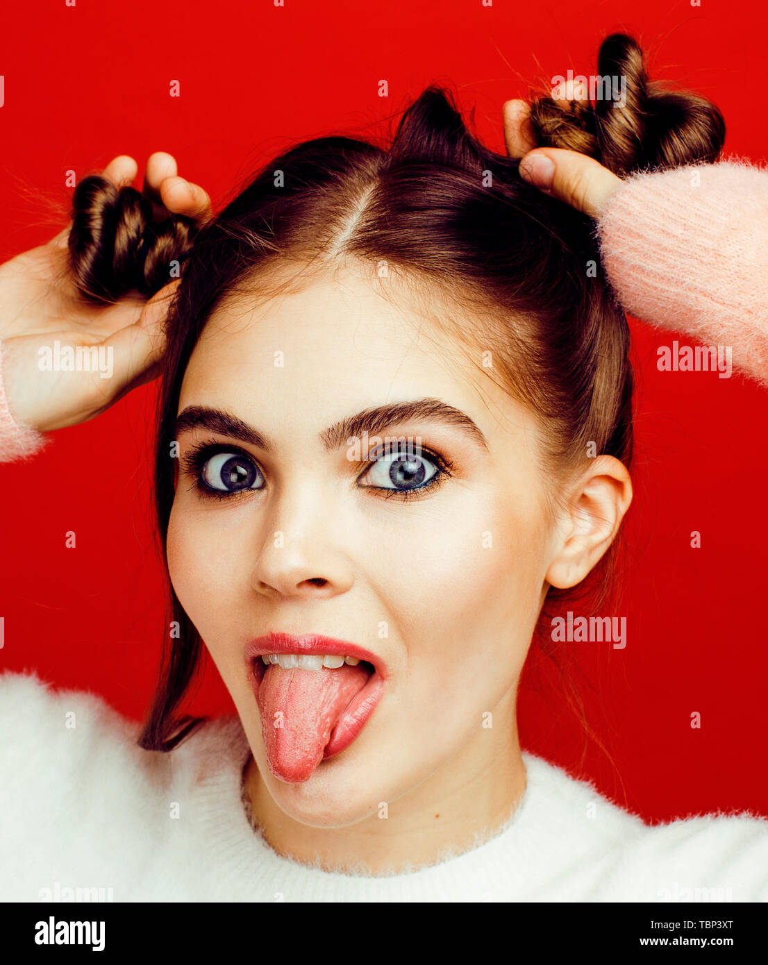 young pretty emitonal posing teenage girl on bright red background ...