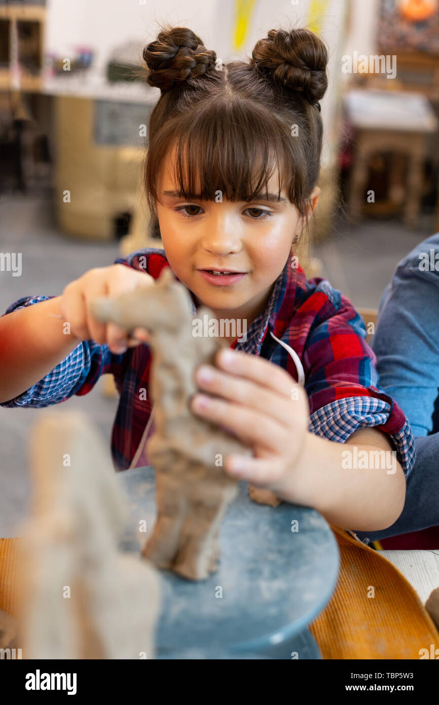Nice hairstyle. Beautiful cute girl with nice hairstyle sculpting clay ...