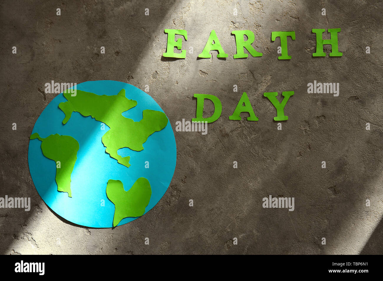 Text EARTH DAY composed from letters and shape of planet on grunge ...