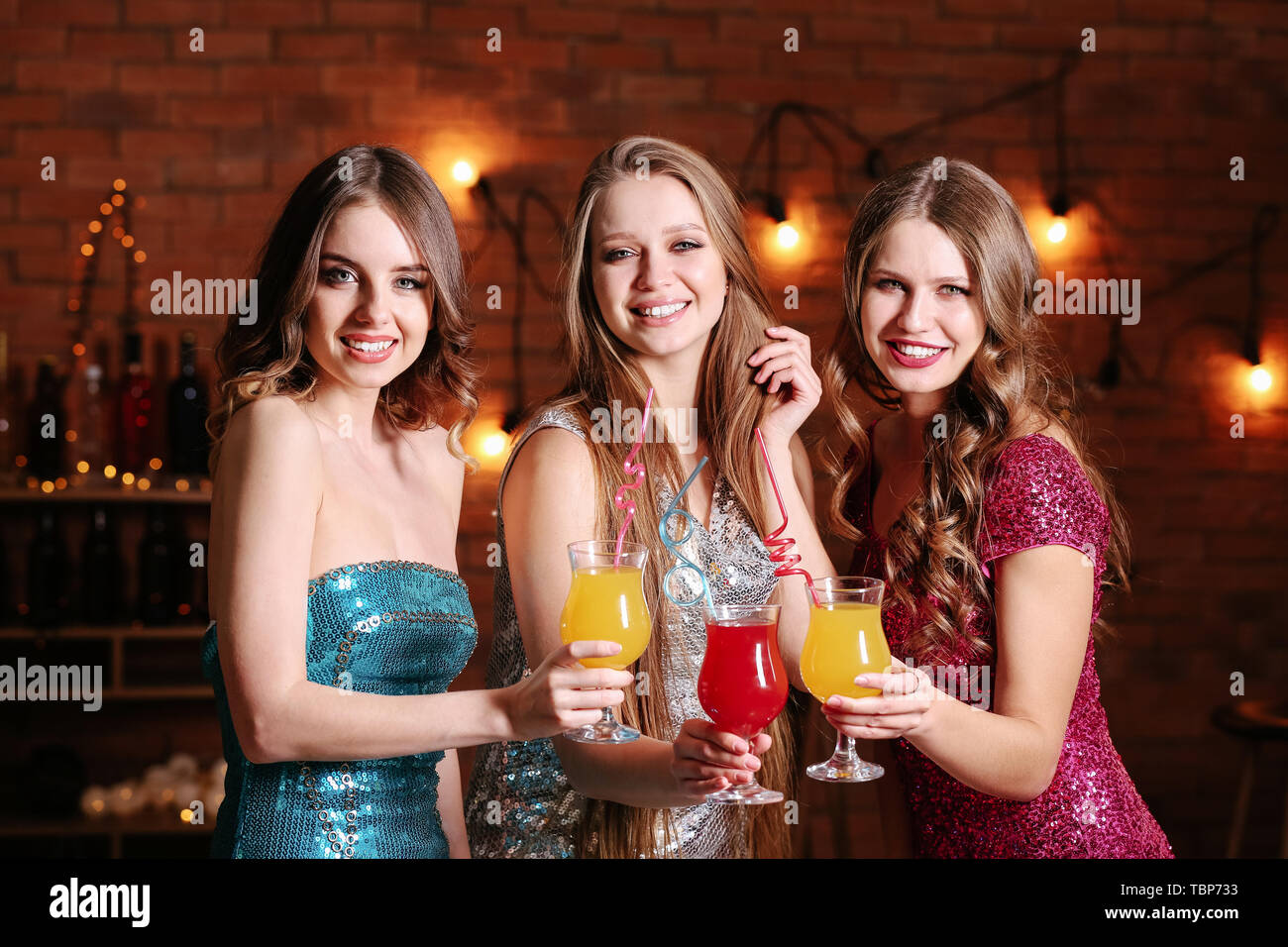 Beautiful young women with cocktails in club Stock Photo - Alamy