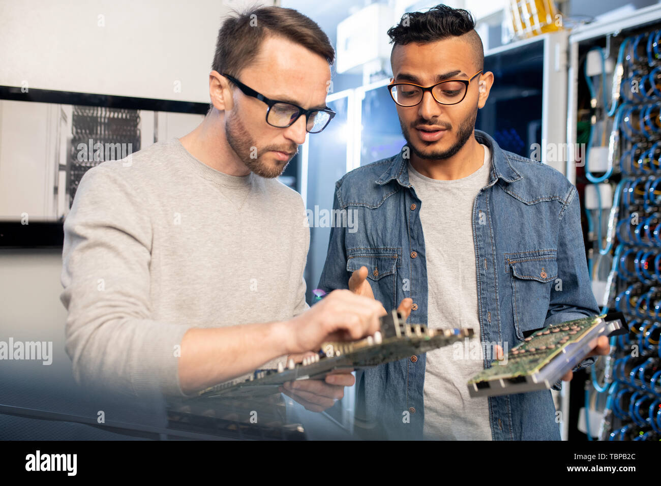 Concentrated smart young database engineers in glasses viewing circuit ...