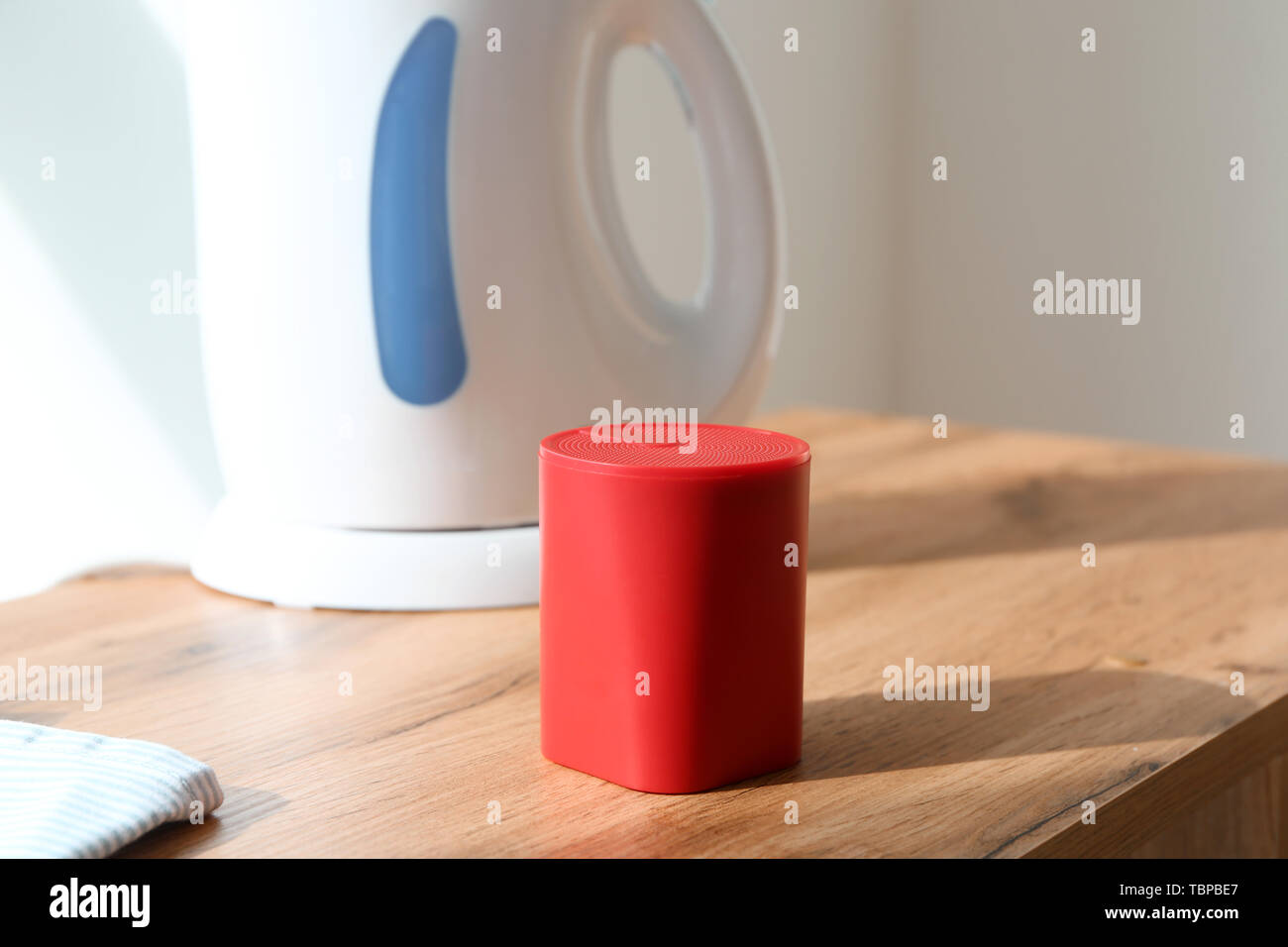 Smart home assistant device on table in room Stock Photo - Alamy