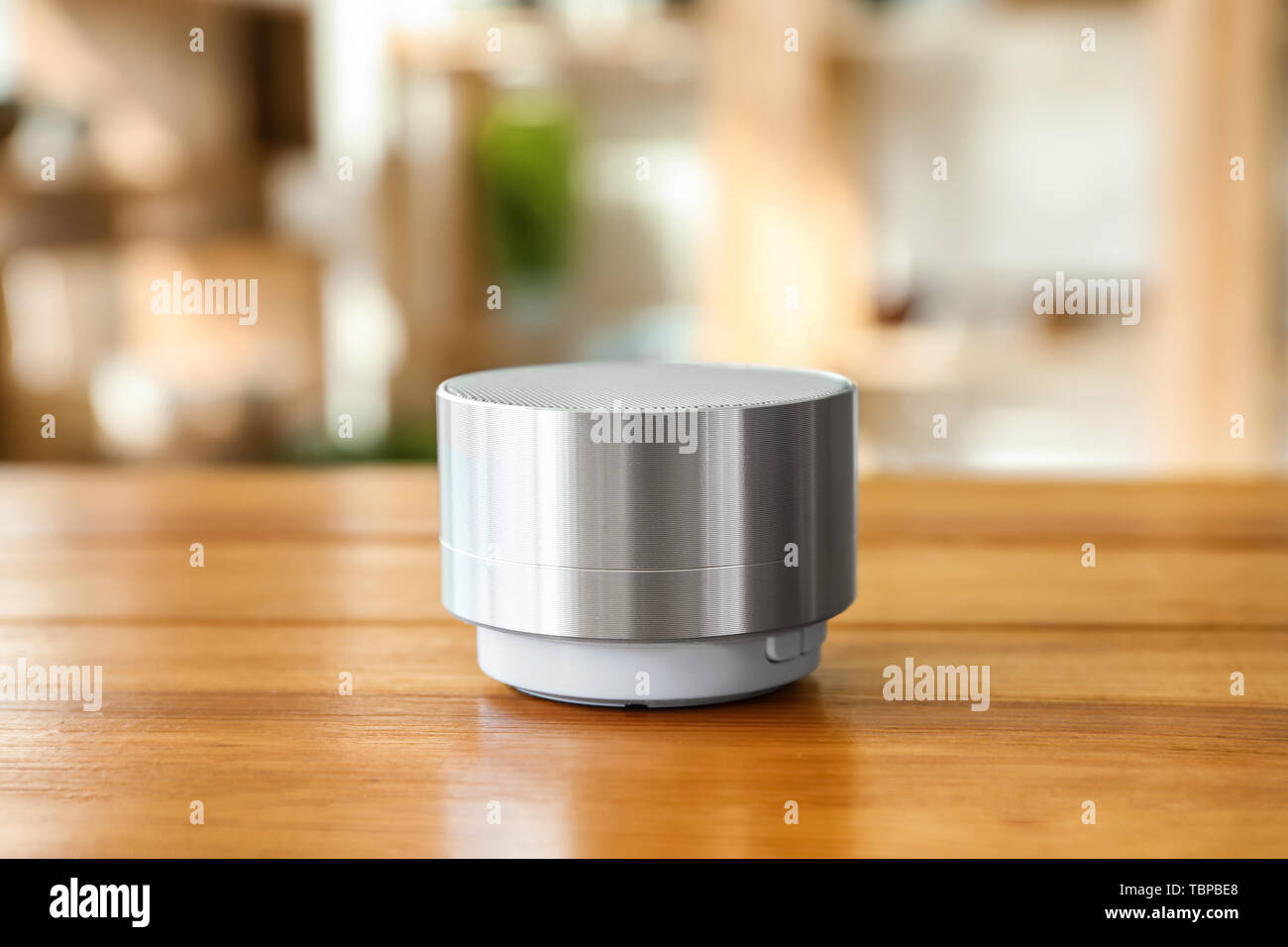 Smart home assistant device on table in room Stock Photo - Alamy