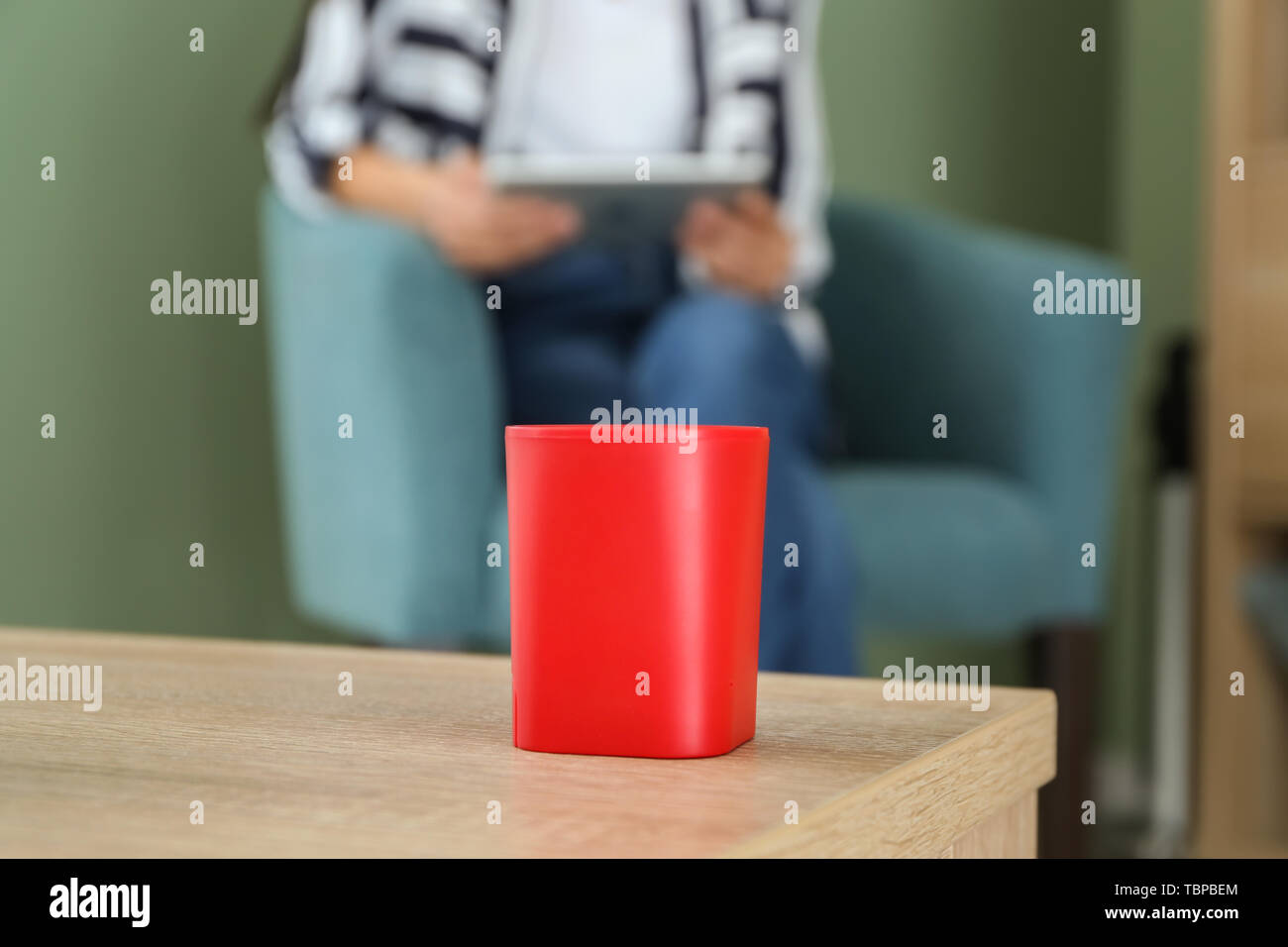 Smart home assistant device on table in room Stock Photo - Alamy