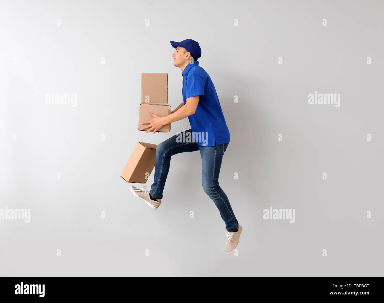Running delivery man boxes hi-res stock photography and images - Alamy