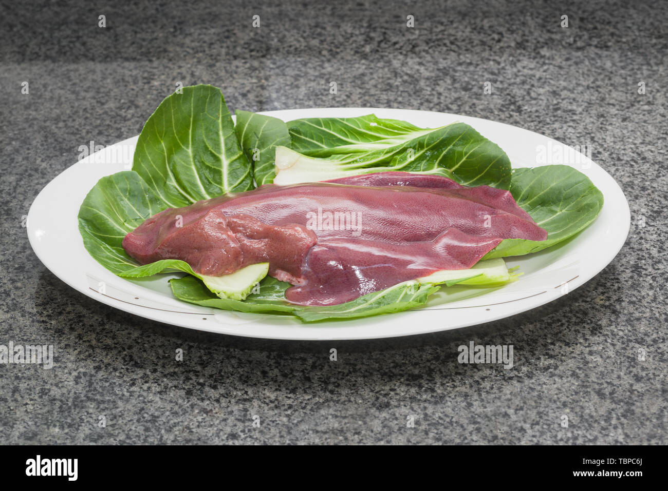 Fresh pig liver in a white porcelain dish Stock Photo - Alamy