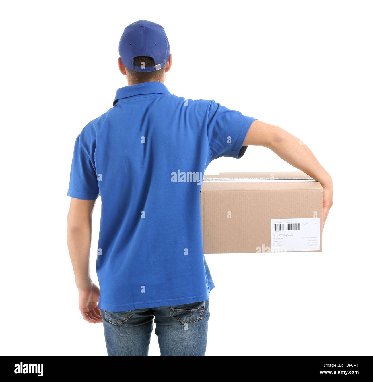 Delivery man with box on white background, back view Stock Photo - Alamy