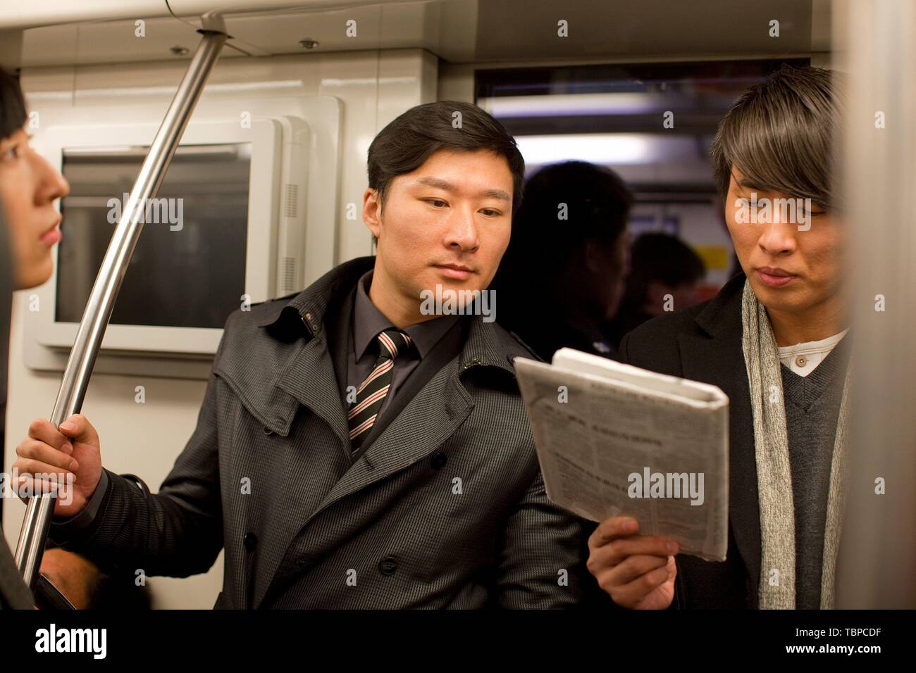 Asian man newspaper train hi-res stock photography and images - Alamy