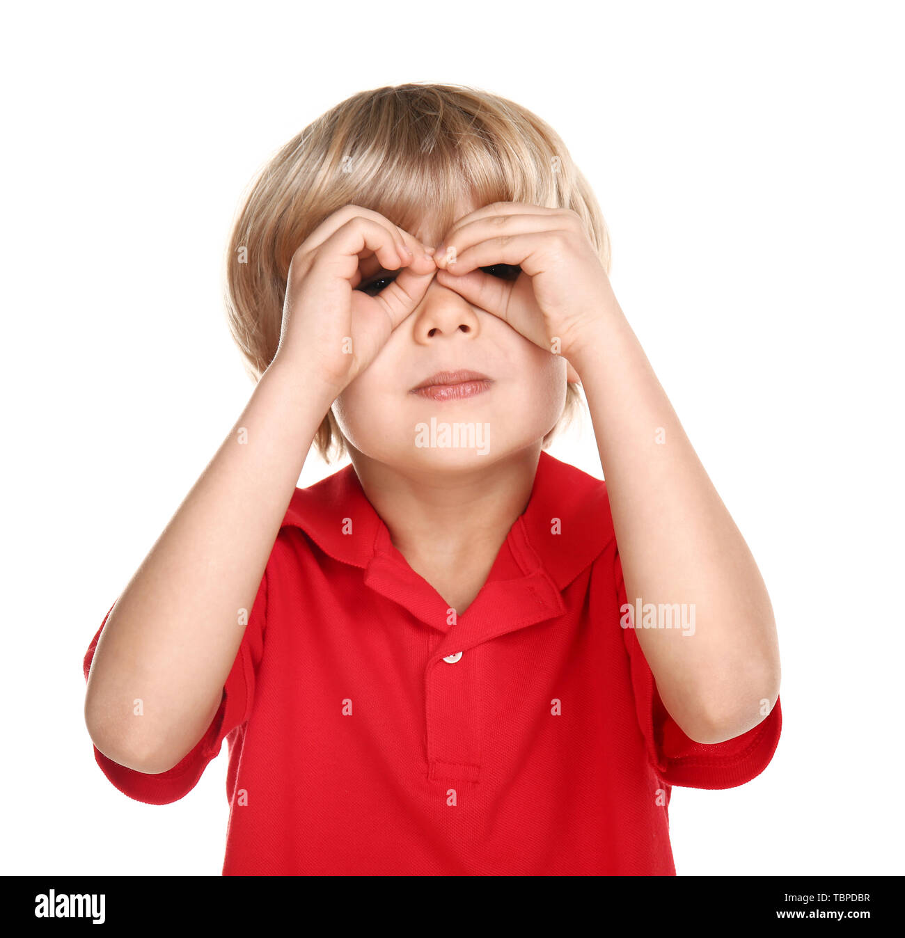 Cute little boy looking through imaginary binocular on white background ...