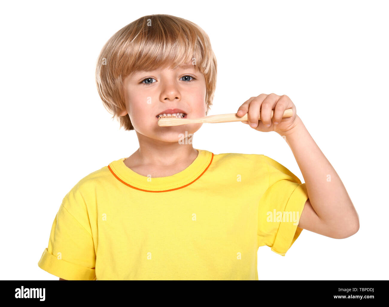 Cute little boy brushing teeth on white background Stock Photo - Alamy
