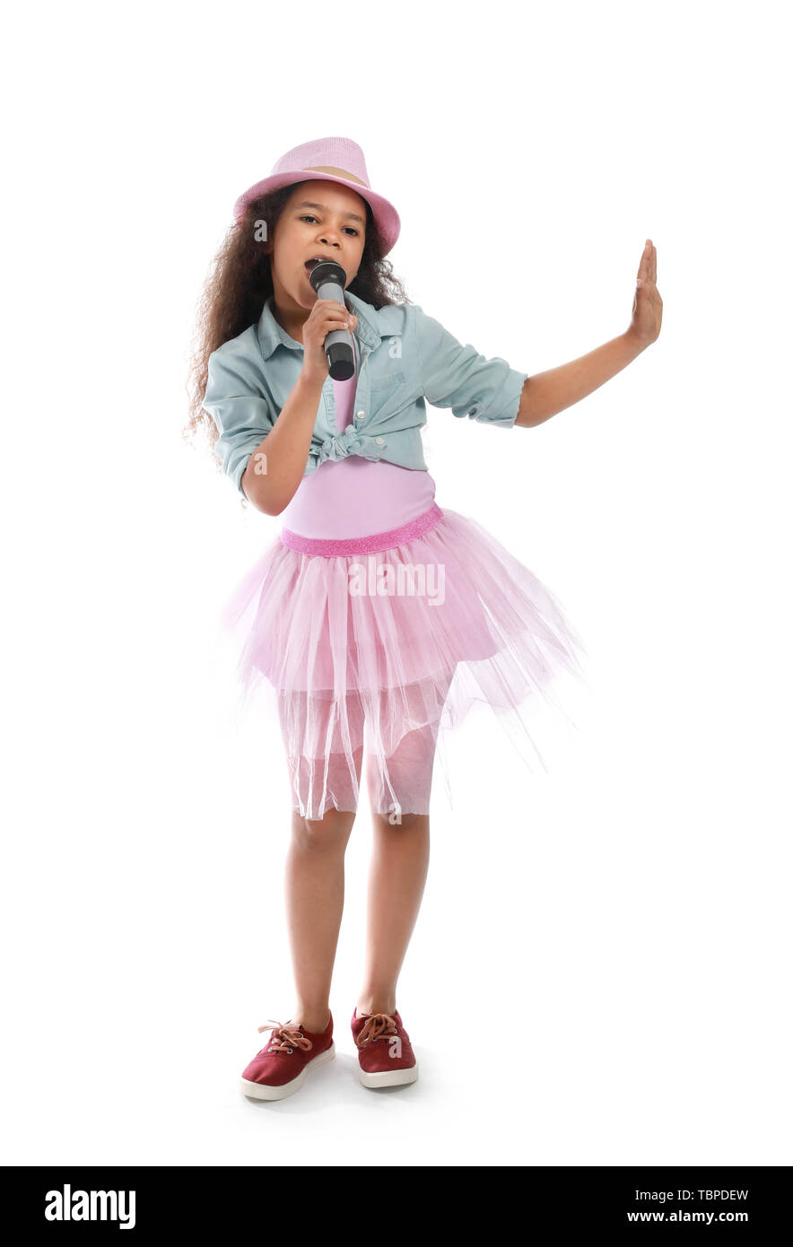 Little African-American singer against white background Stock Photo - Alamy