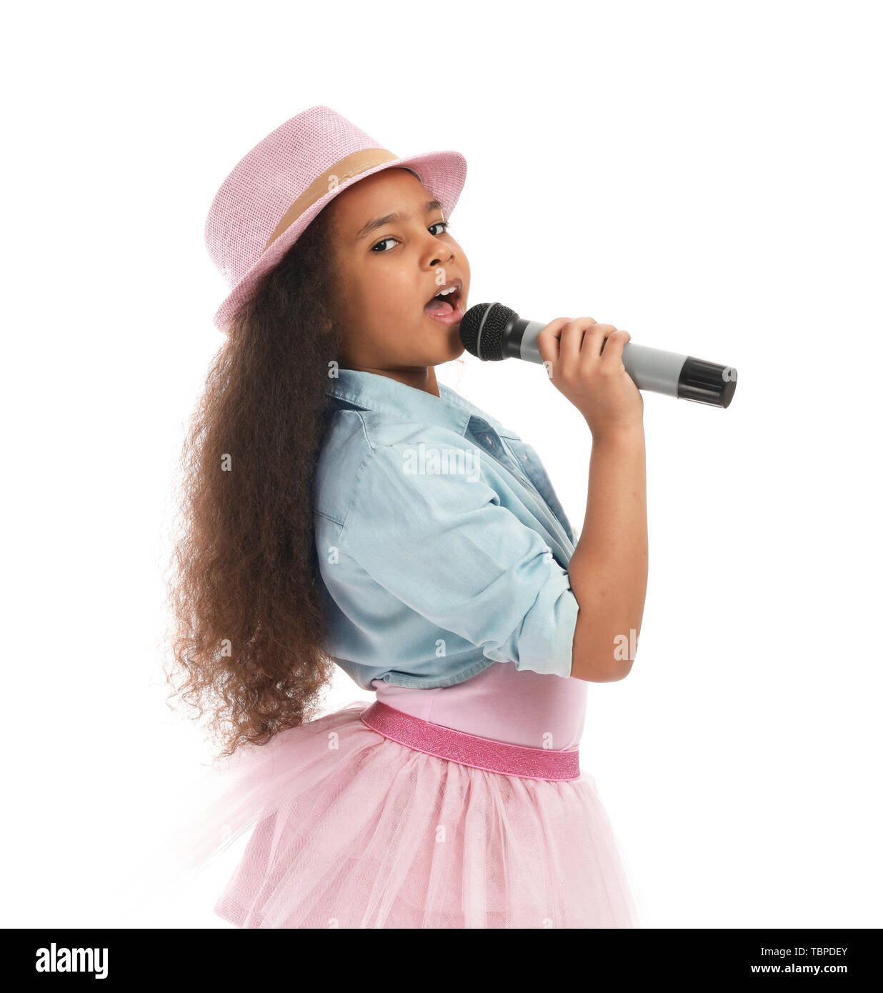 Little African-American singer against white background Stock Photo - Alamy