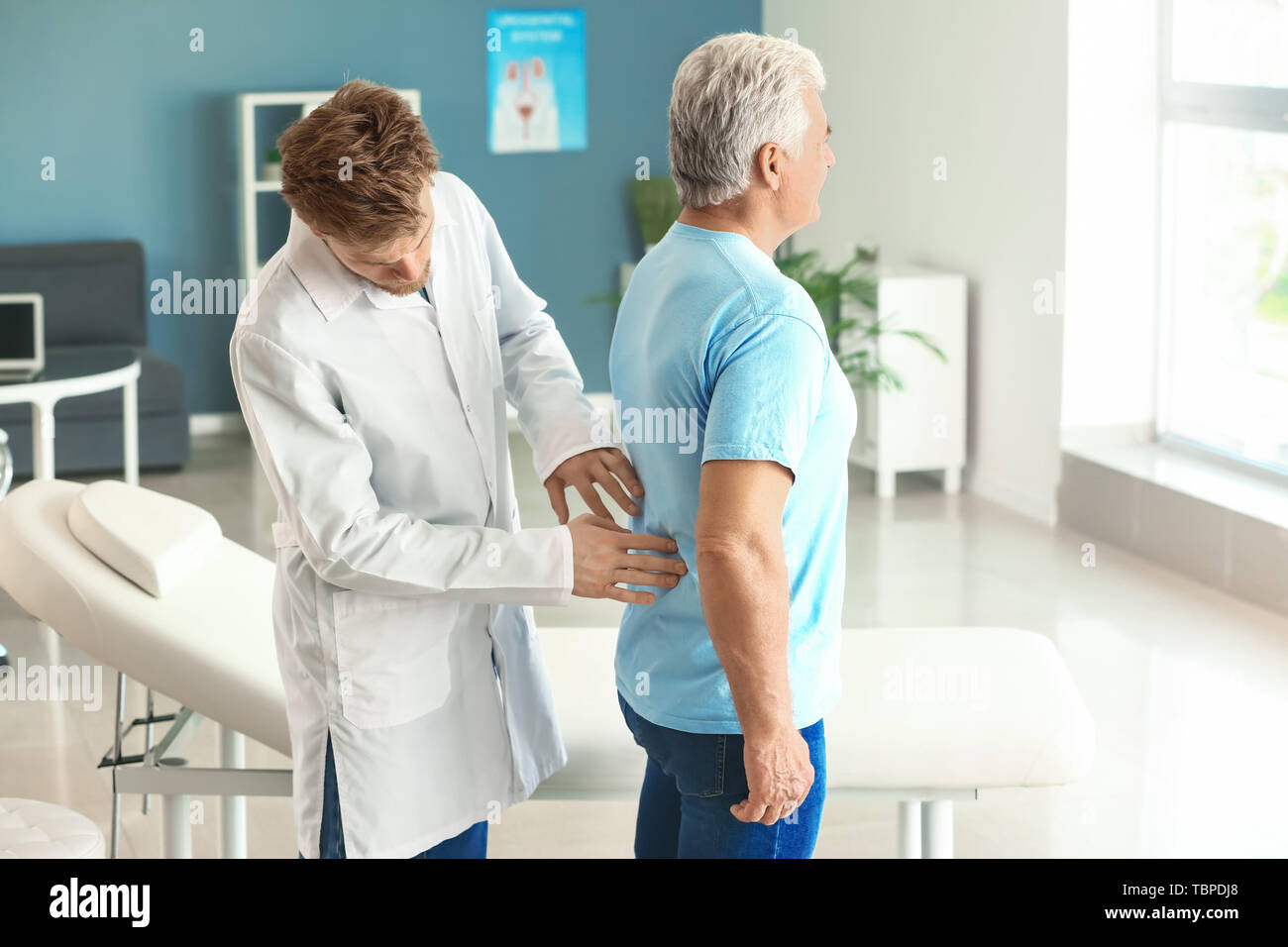 Urologist examining male patient in clinic Stock Photo - Alamy