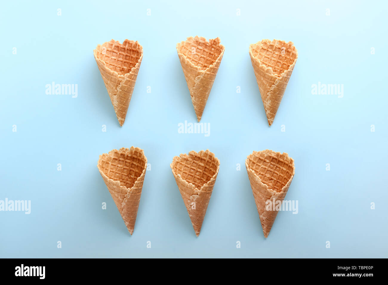 Crunchy wafer cones on color background Stock Photo - Alamy