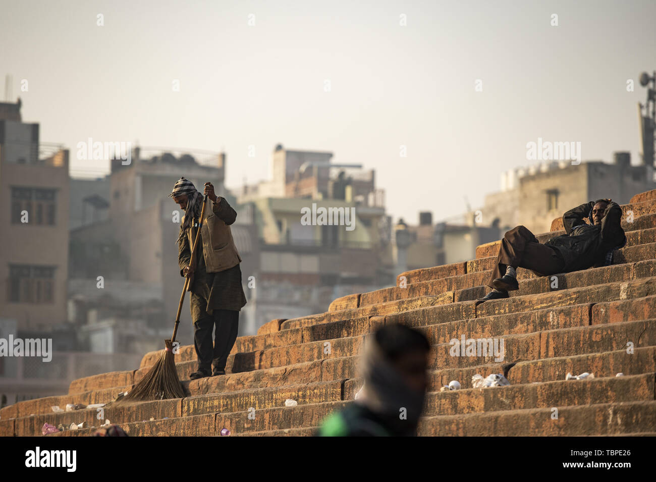 An Indian worker is sweeping the courtyard of the Jama Masjid in New ...