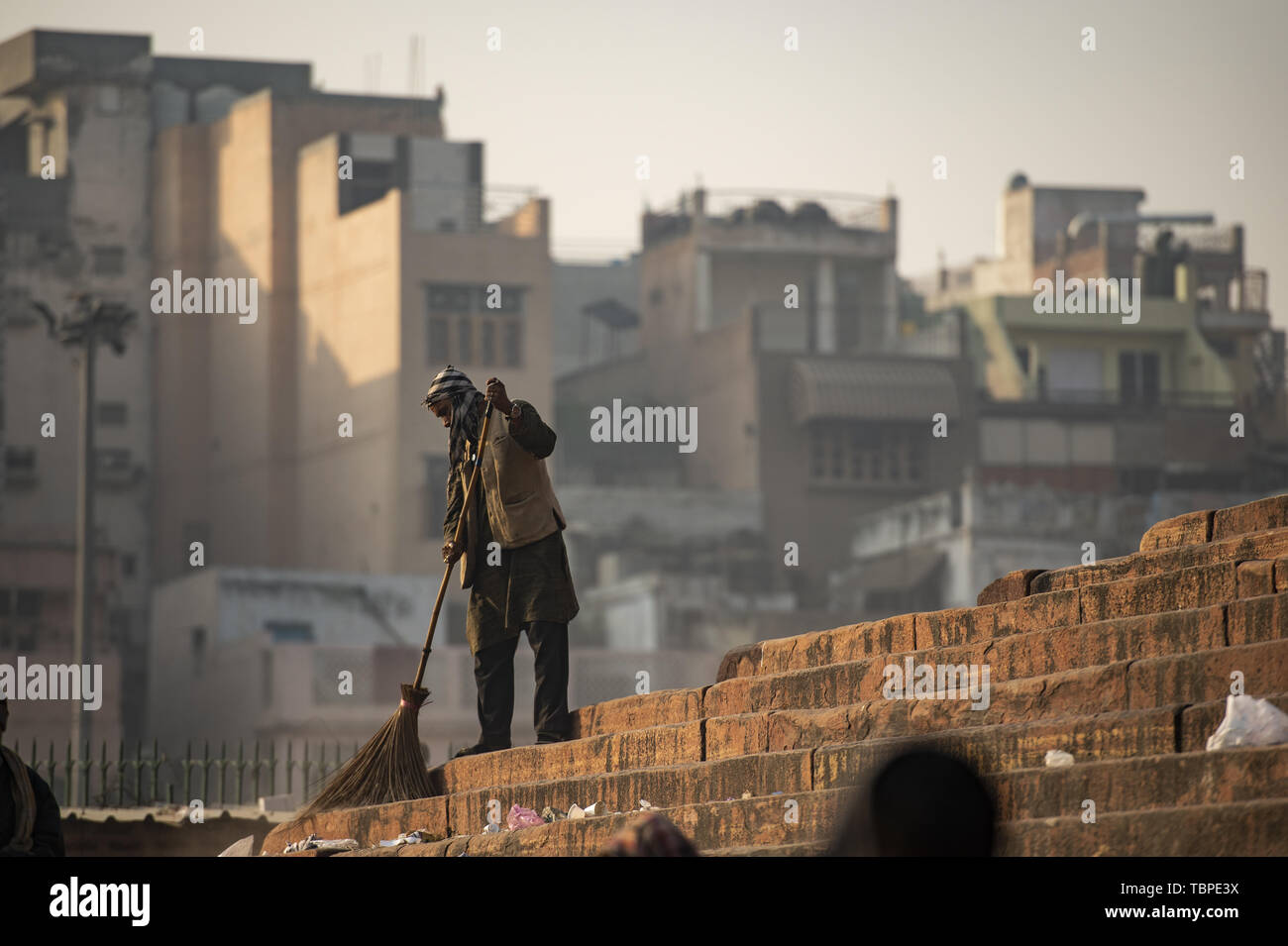 An Indian worker is sweeping the courtyard of the Jama Masjid in New ...