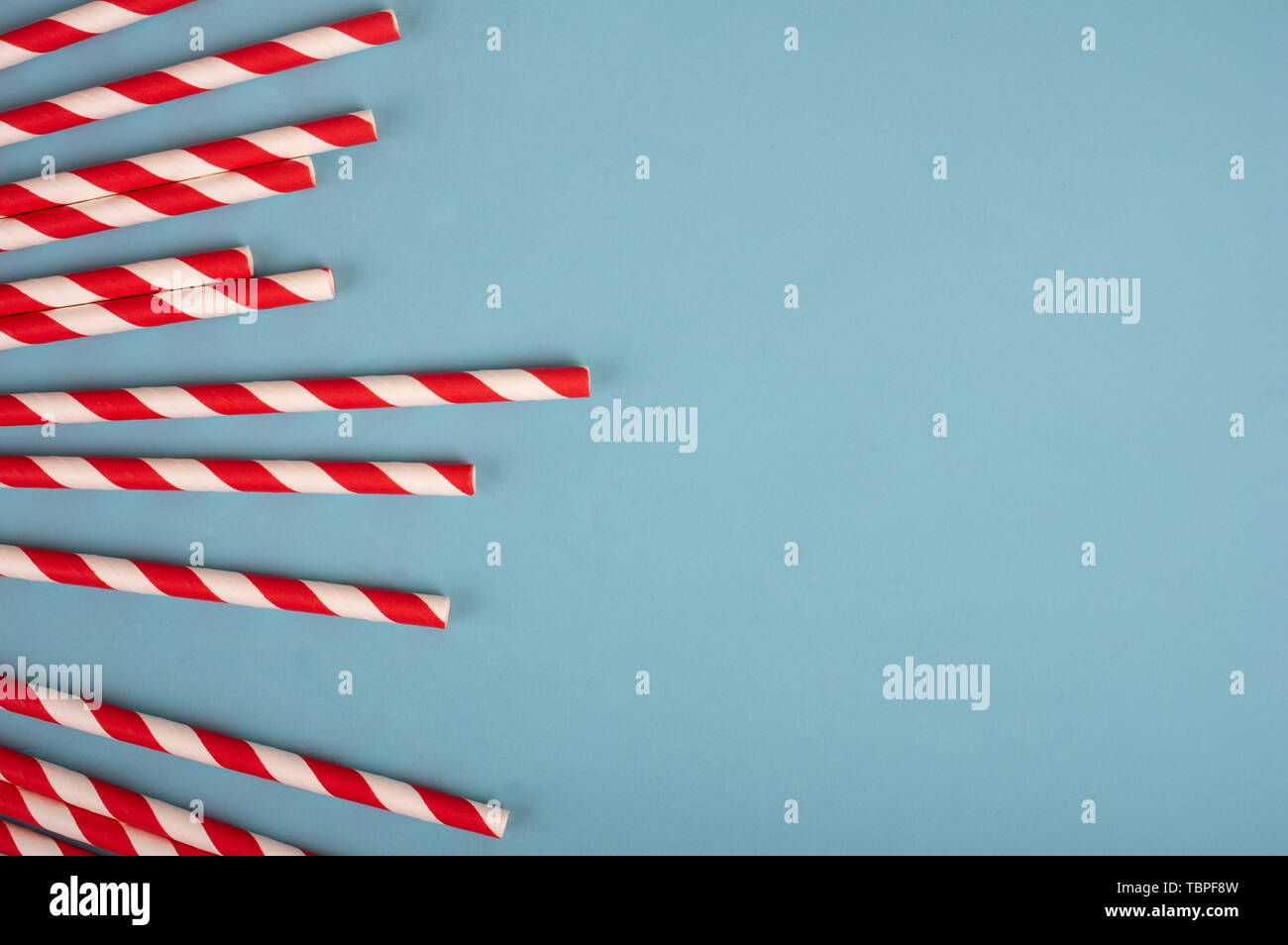 Red eco-friendly paper straw on light blue background Stock Photo - Alamy