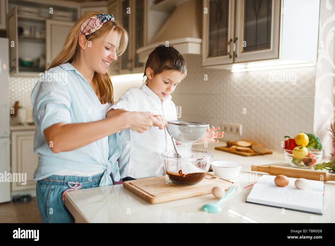 Boy mixing chocolate in kitchen hi-res stock photography and images - Alamy