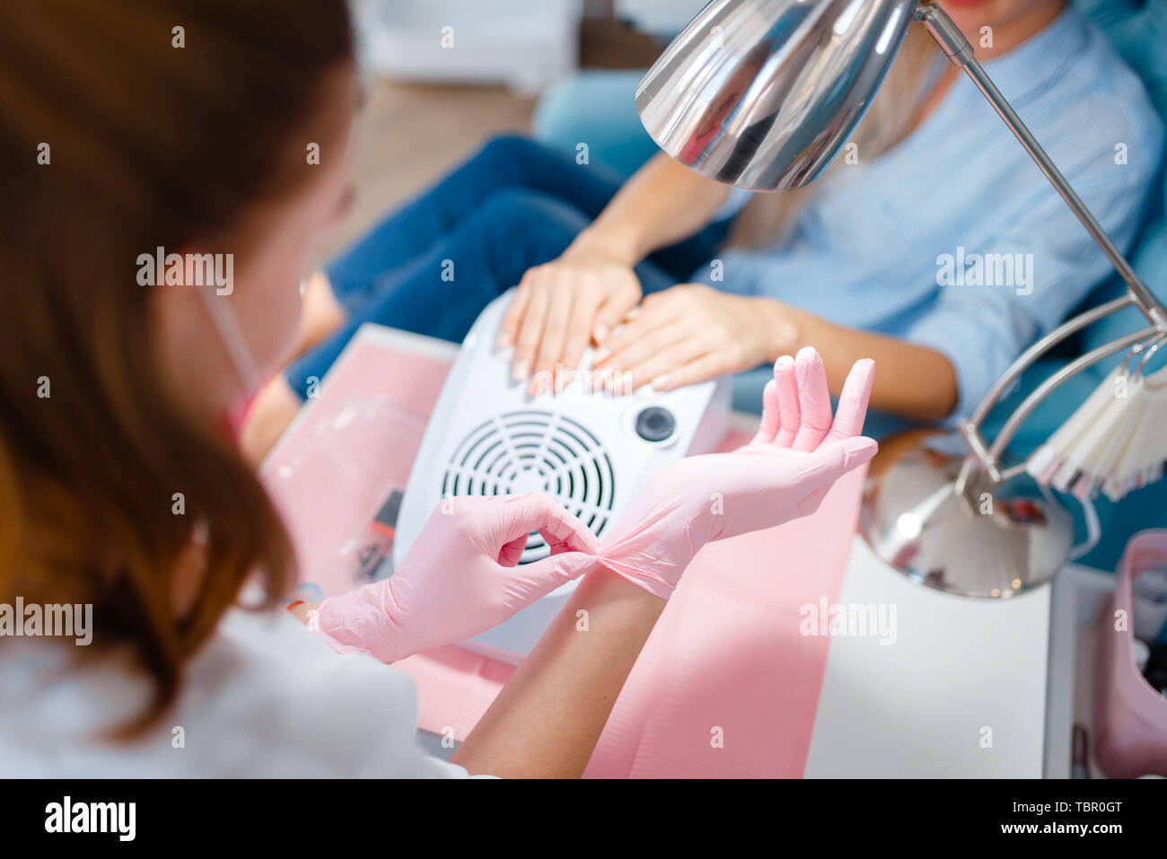 Beautician salon, manicure, nails drying procedure Stock Photo - Alamy