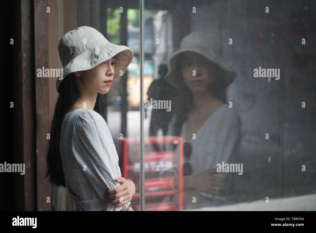 The girl in front of the glass window Stock Photo - Alamy