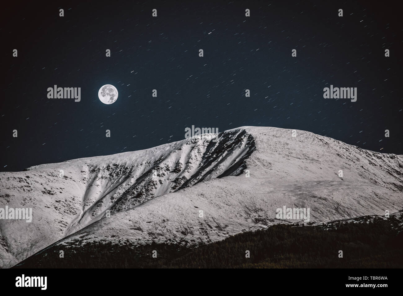 Moonlight illuminates the top of the mountain Stock Photo - Alamy
