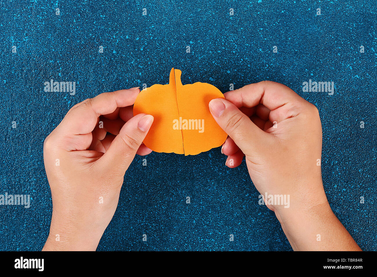 Diy Halloween paper bracelet pumpkin on black background. Gift idea ...
