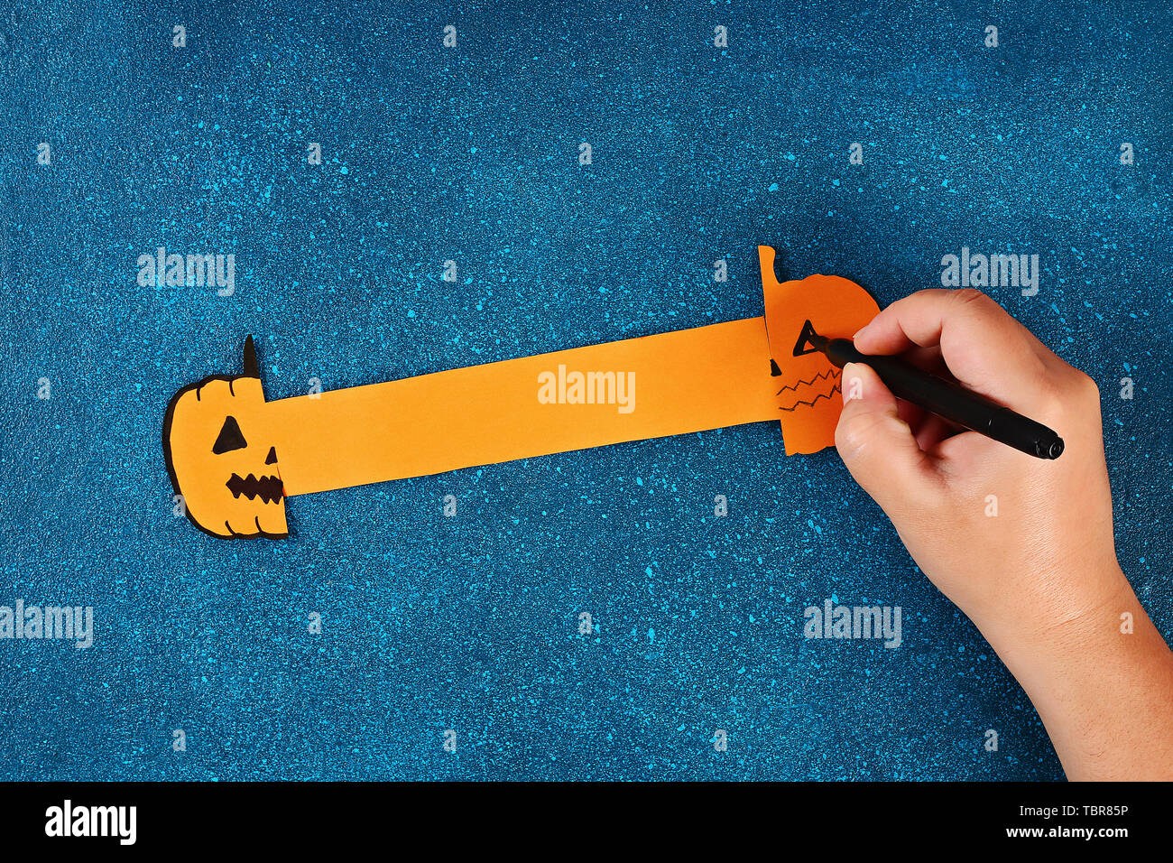 Diy Halloween paper bracelet pumpkin on black background. Gift idea ...