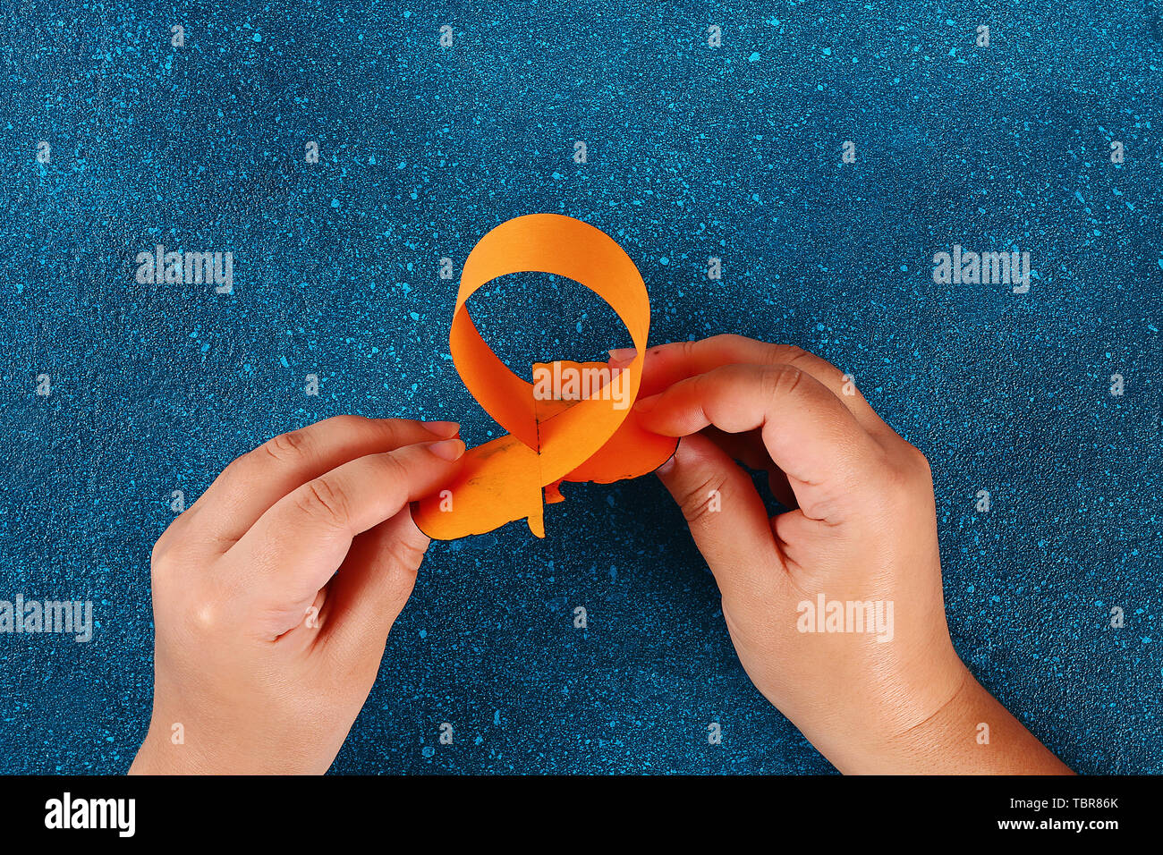Diy Halloween paper bracelet pumpkin on black background. Gift idea ...