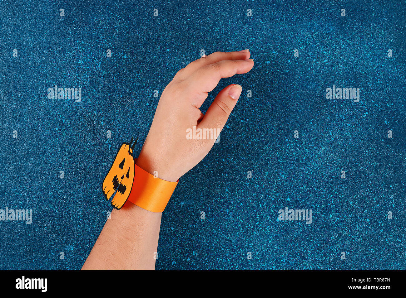 Diy Halloween paper bracelet pumpkin on black background. Gift idea ...