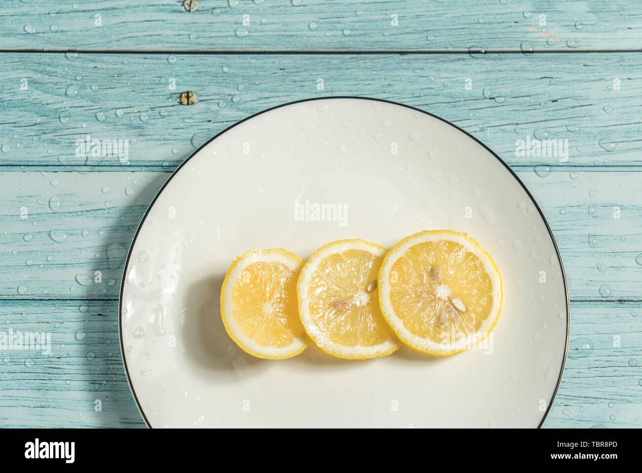 Lemon with teal wood pattern background Stock Photo - Alamy