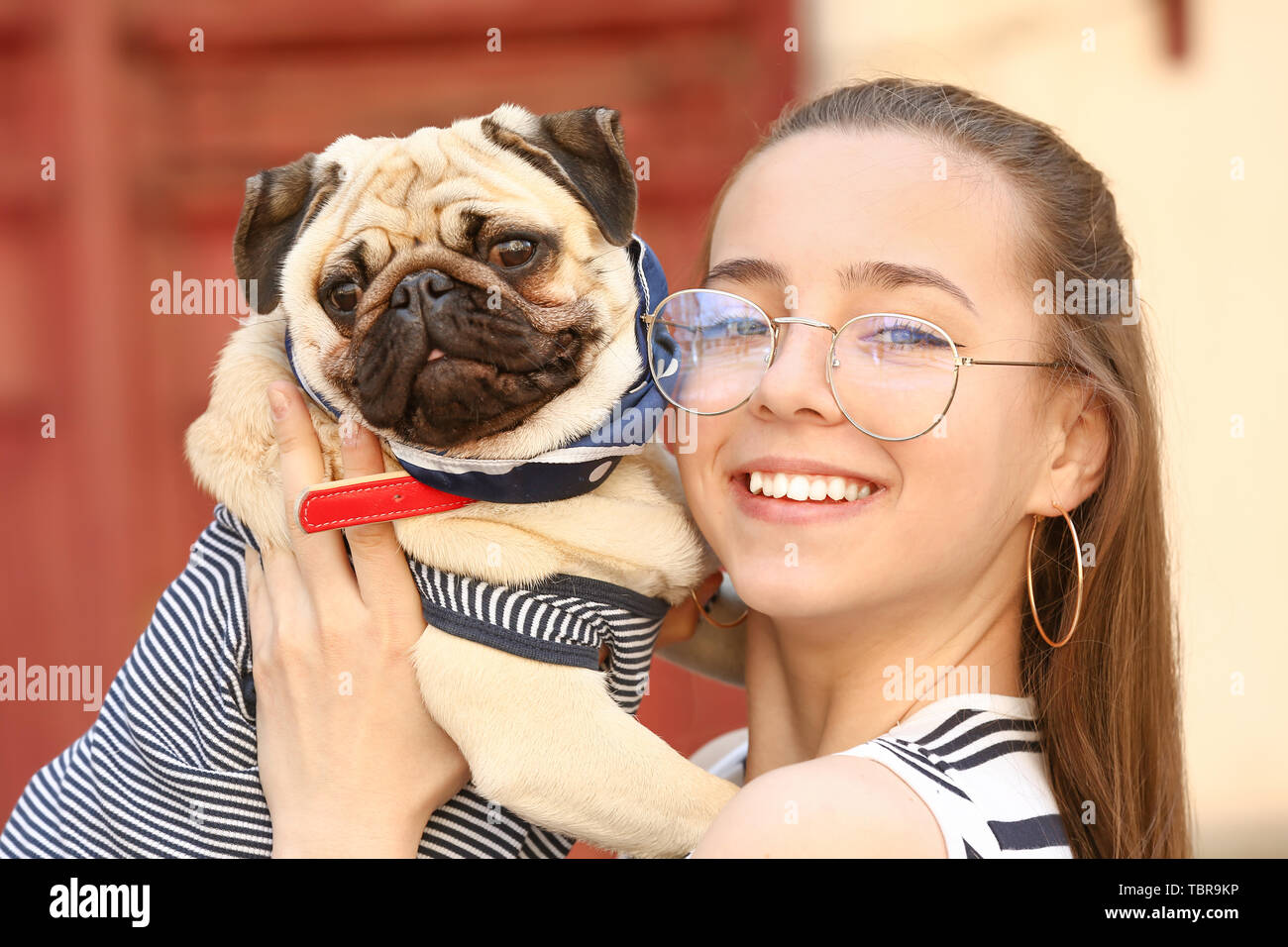 Teenage girl with cute pug dog outdoors Stock Photo - Alamy