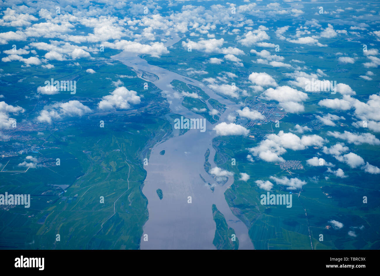 Aerial shot of mountains, fields, villages, towns under the blue sky ...