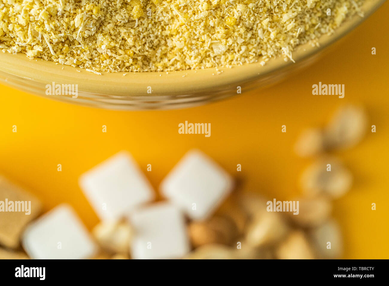 Bowl of Nigerian Yellow Garri in Yellow bowl with Peanuts and Sugar ...