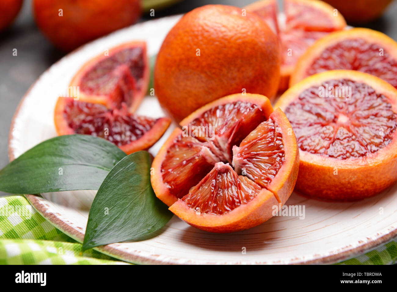 Fresh blood oranges on plate Stock Photo - Alamy