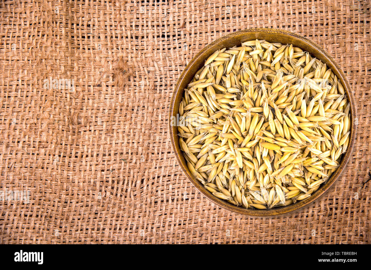 Oat ears stems in cup on the sackcloth background Stock Photo - Alamy