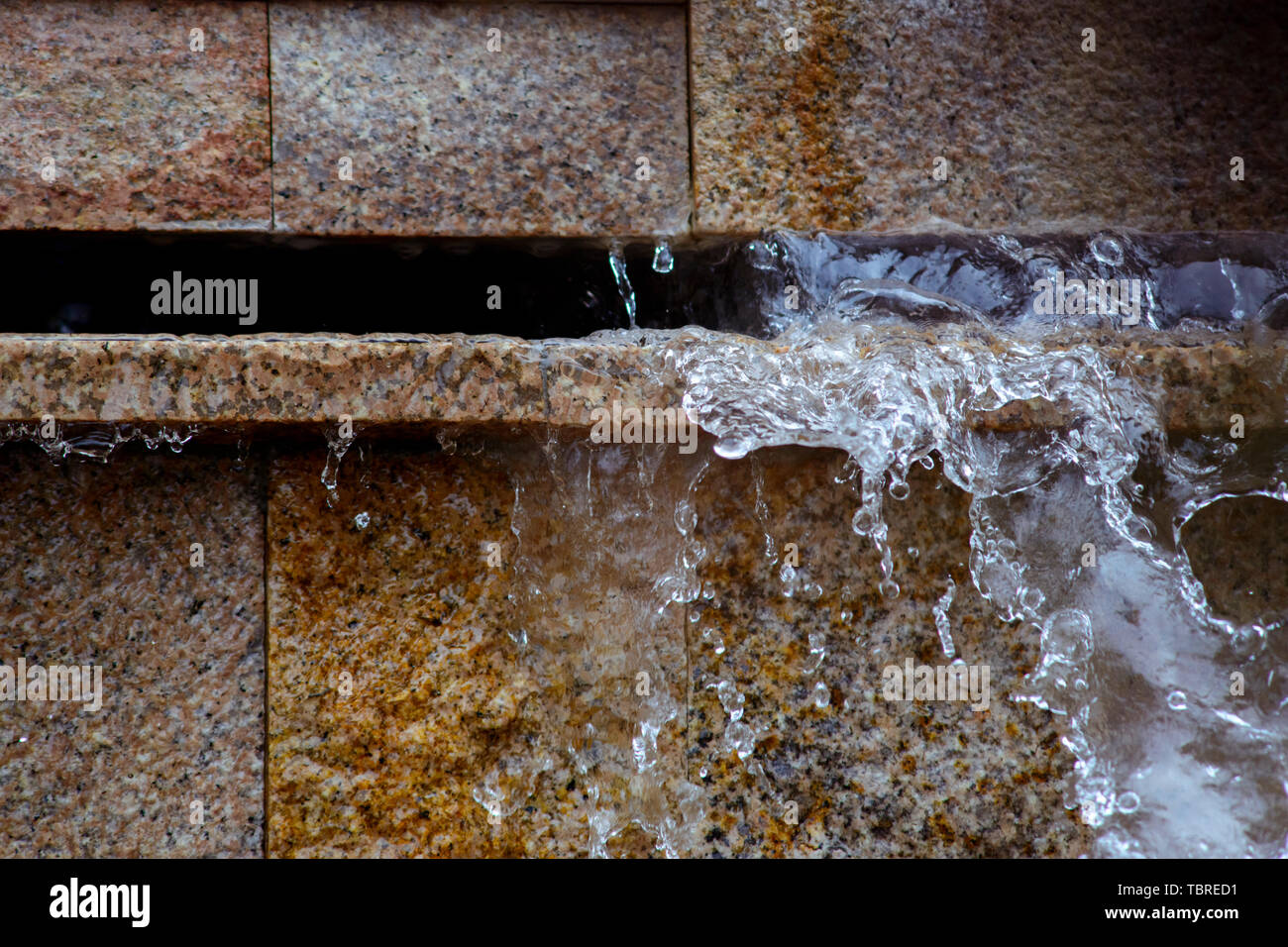 A bead of water formed by flowing water Stock Photo - Alamy