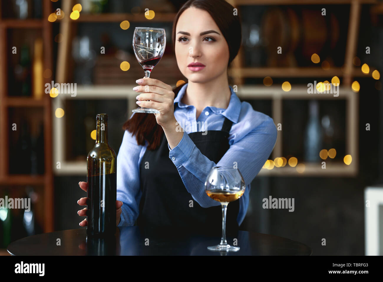 Female sommelier working in wine cellar Stock Photo - Alamy