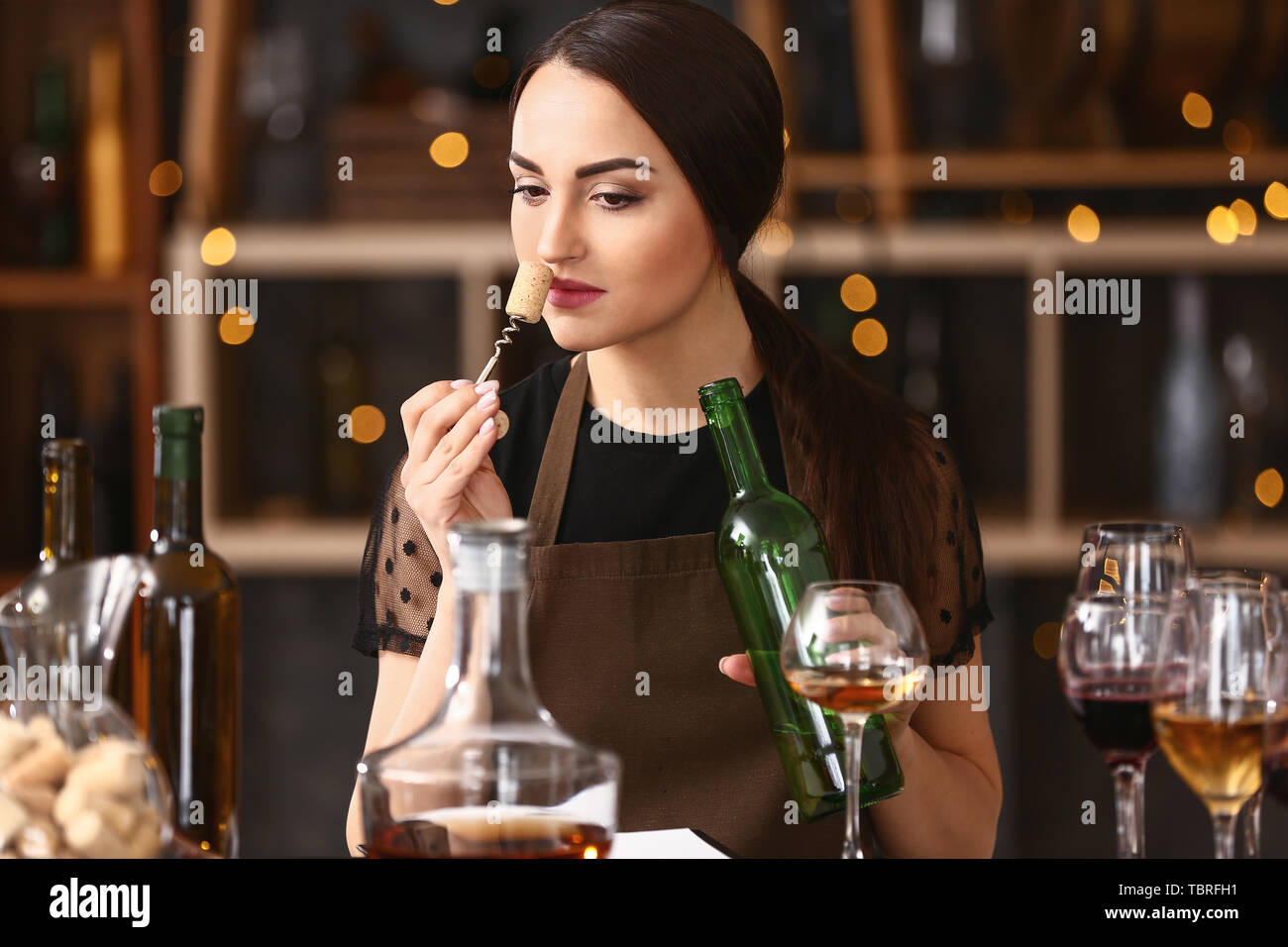 Female sommelier working in wine cellar Stock Photo - Alamy