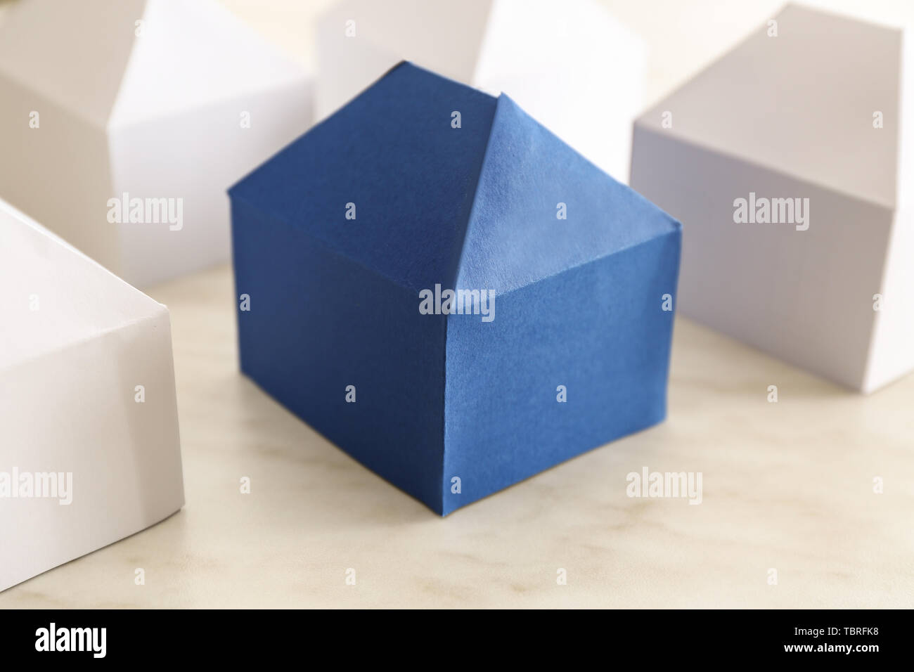 Paper models of houses on table Stock Photo - Alamy