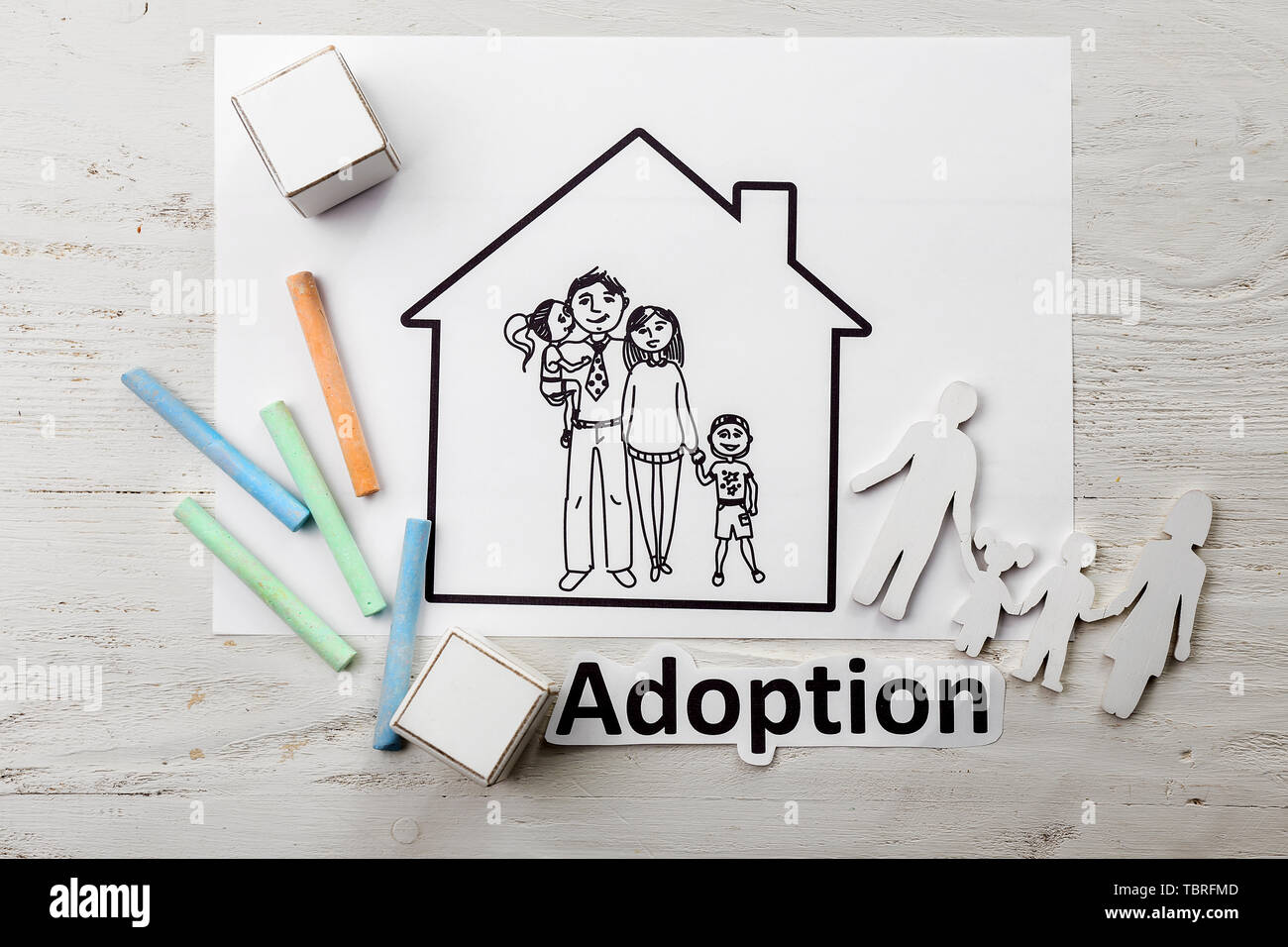 Drawing of family and word ADOPTION on white wooden table Stock Photo ...
