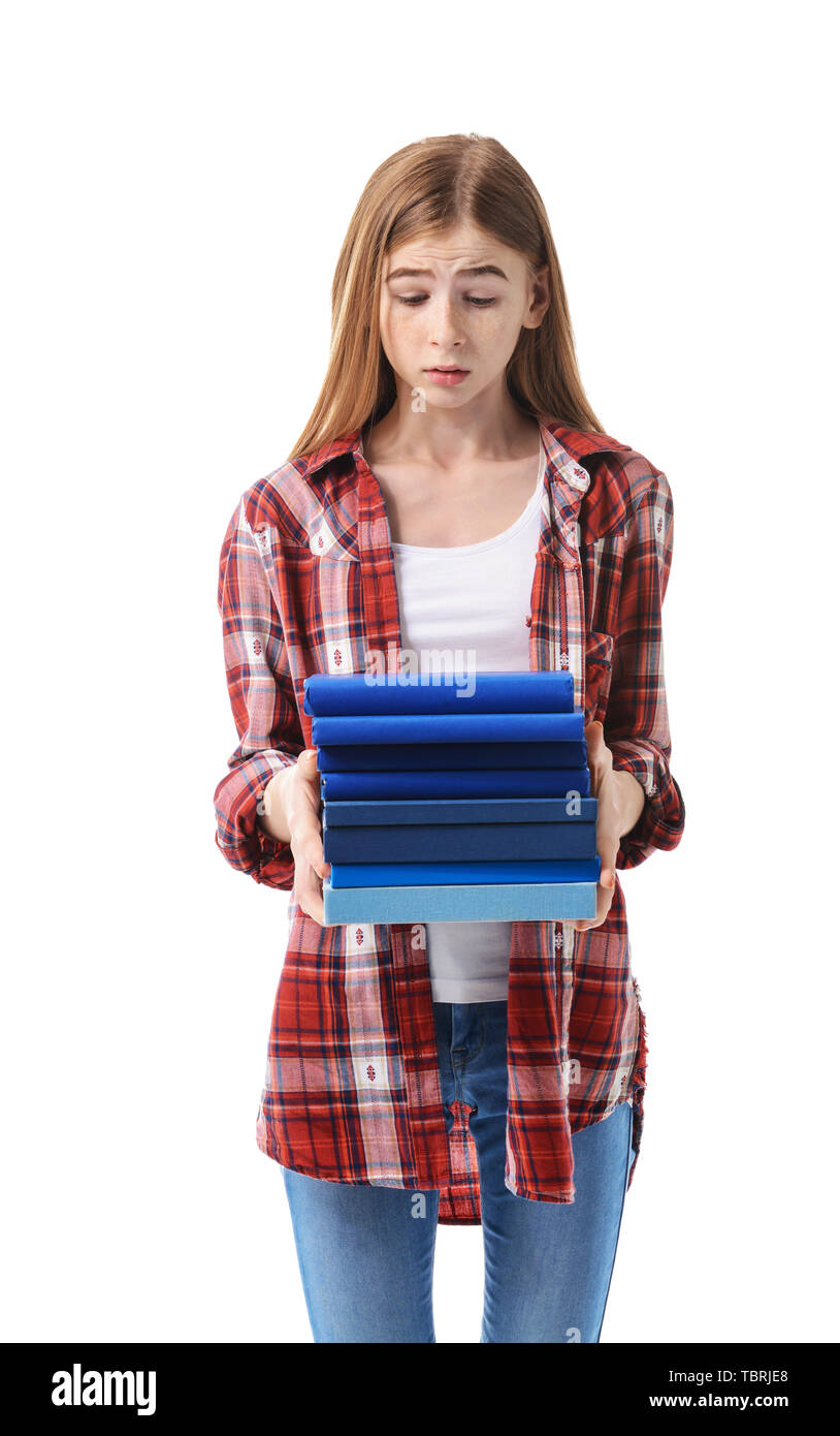 Stressed teenage girl with a lot of books on white background Stock ...
