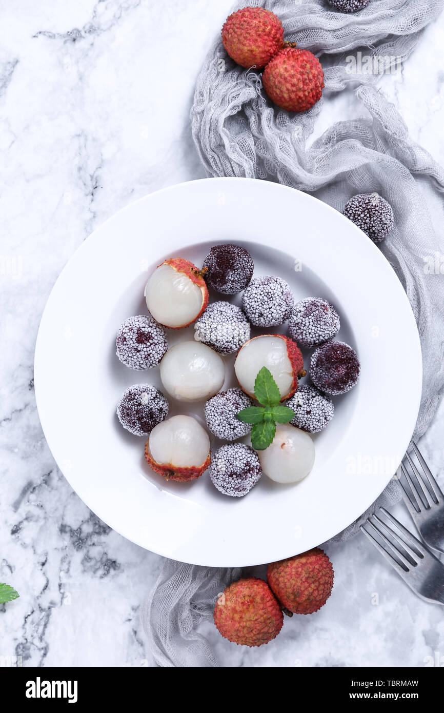 Frozen plum and fresh lychee Stock Photo - Alamy