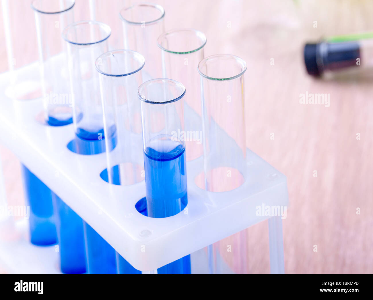 set of test tubes with blue liquid on the desktop Stock Photo - Alamy