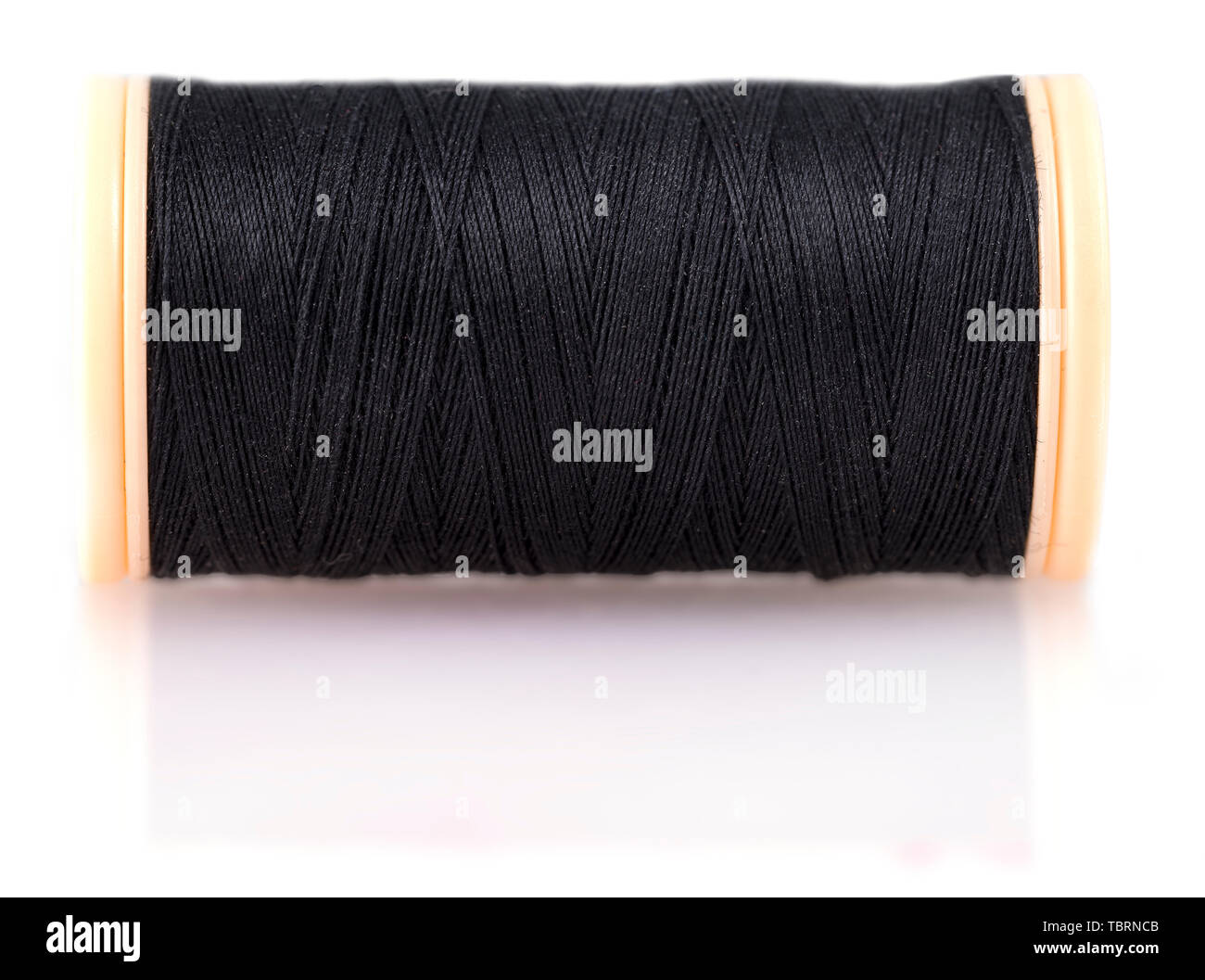 bobbin with black thread on a white background Stock Photo - Alamy