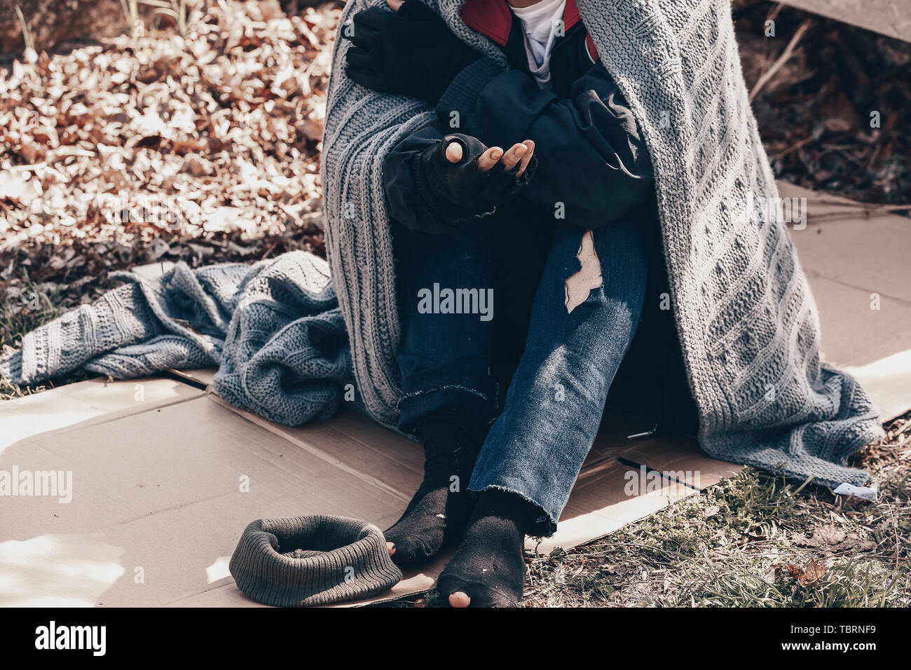 Poor homeless woman begging for help outdoors Stock Photo - Alamy