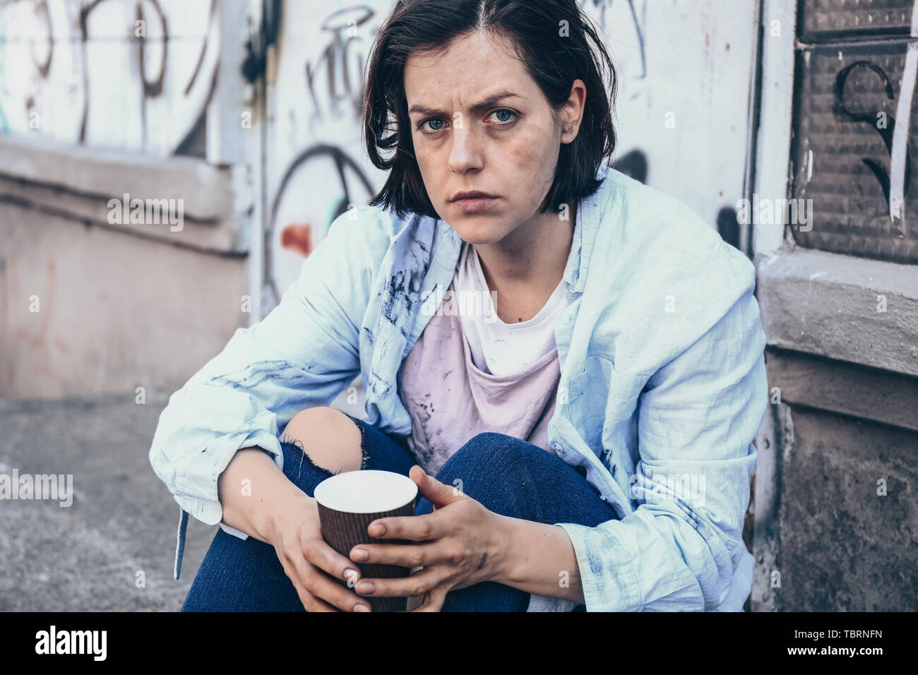 Poor homeless woman begging for help outdoors Stock Photo - Alamy