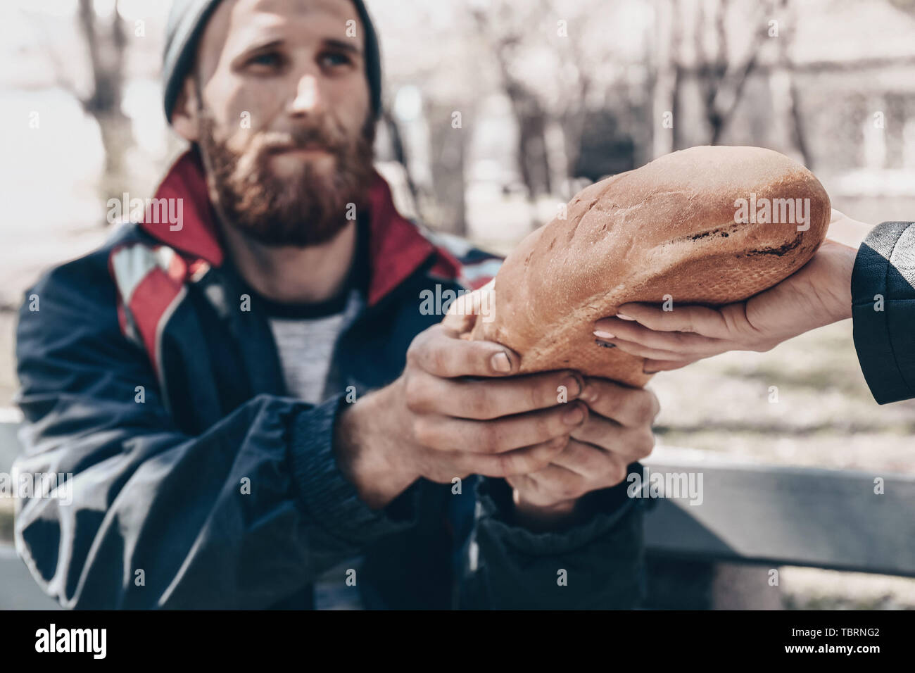 Beggar woman eating bread hi-res stock photography and images - Alamy